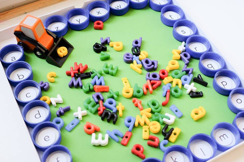 Such a clever way to use bottle caps while working on letter ...
